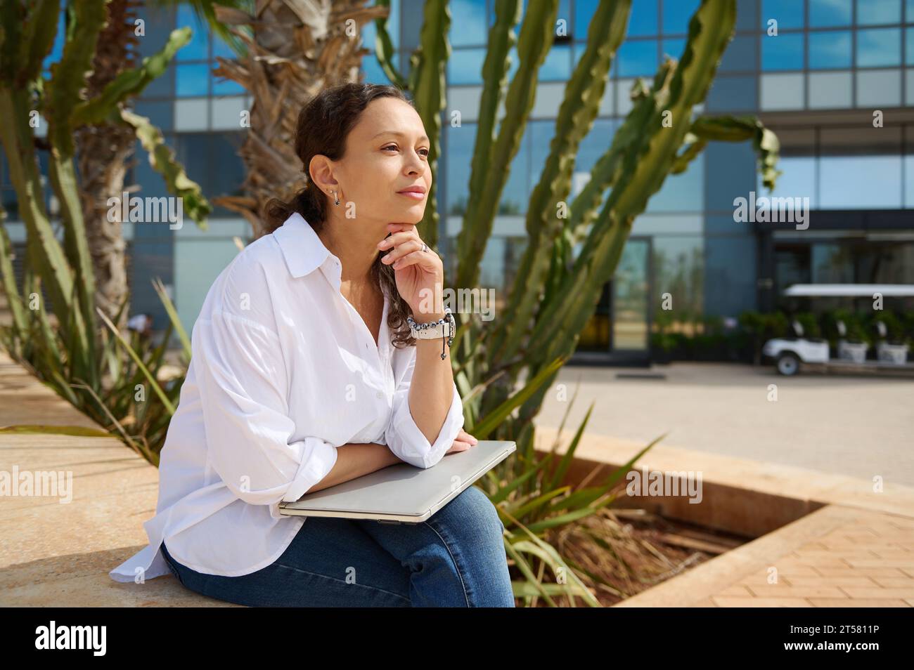 Beautiful confident multi ethnic young woman in casual clothes, sitting ...