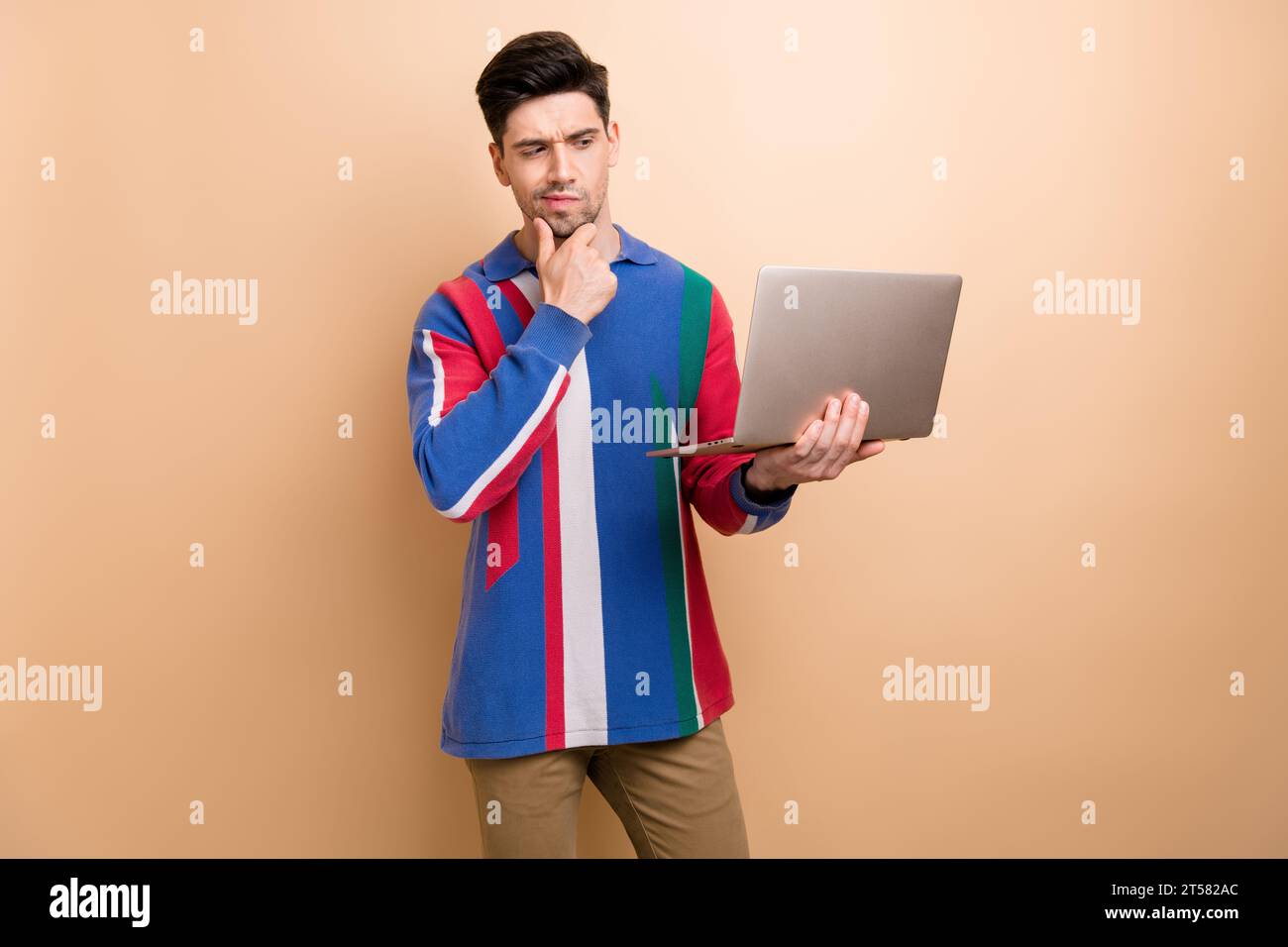 Portrait of minded pensive person hand touch chin use netbook coworking ...