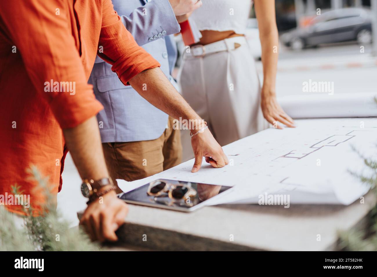 Architectural team discusses blueprint, plans, and costs. Collaboration ...