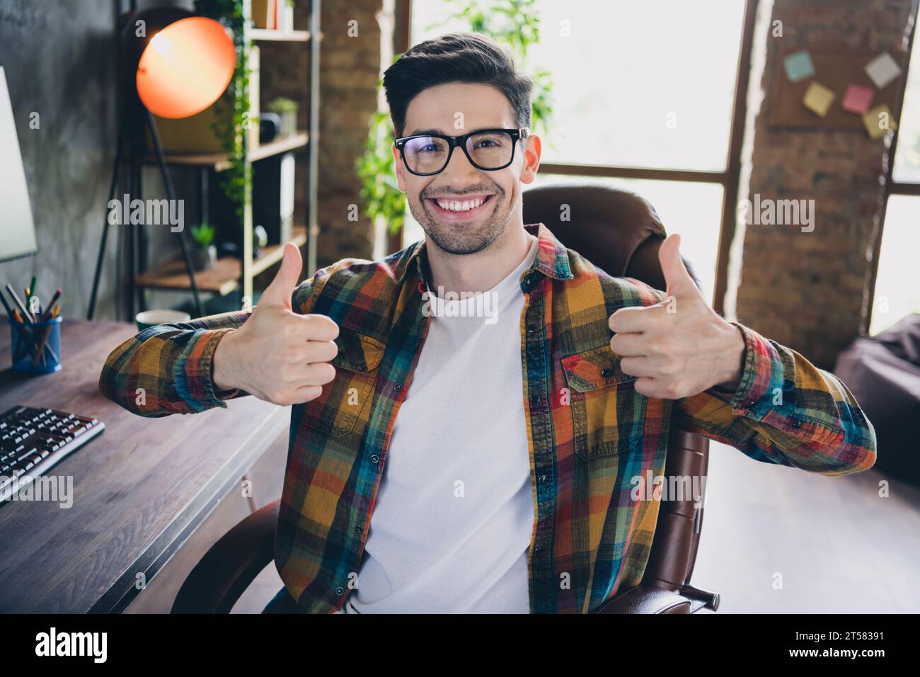 Photo of happy web designer sitting chair hands fingers demonstrate ...