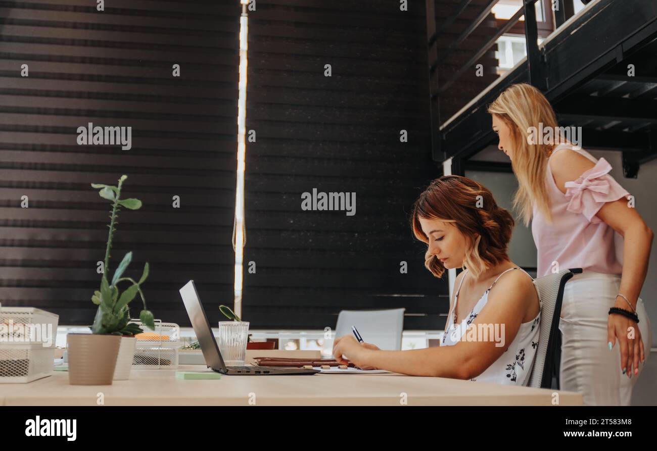 Female employees collaborating on project, utilizing critical thinking ...