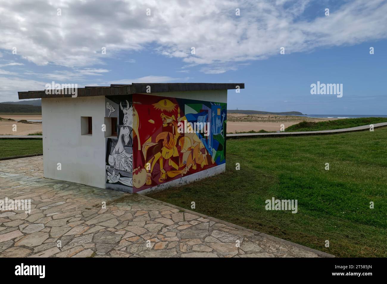 beach side building decorated with colorful mural of Picasso's Guernika ...