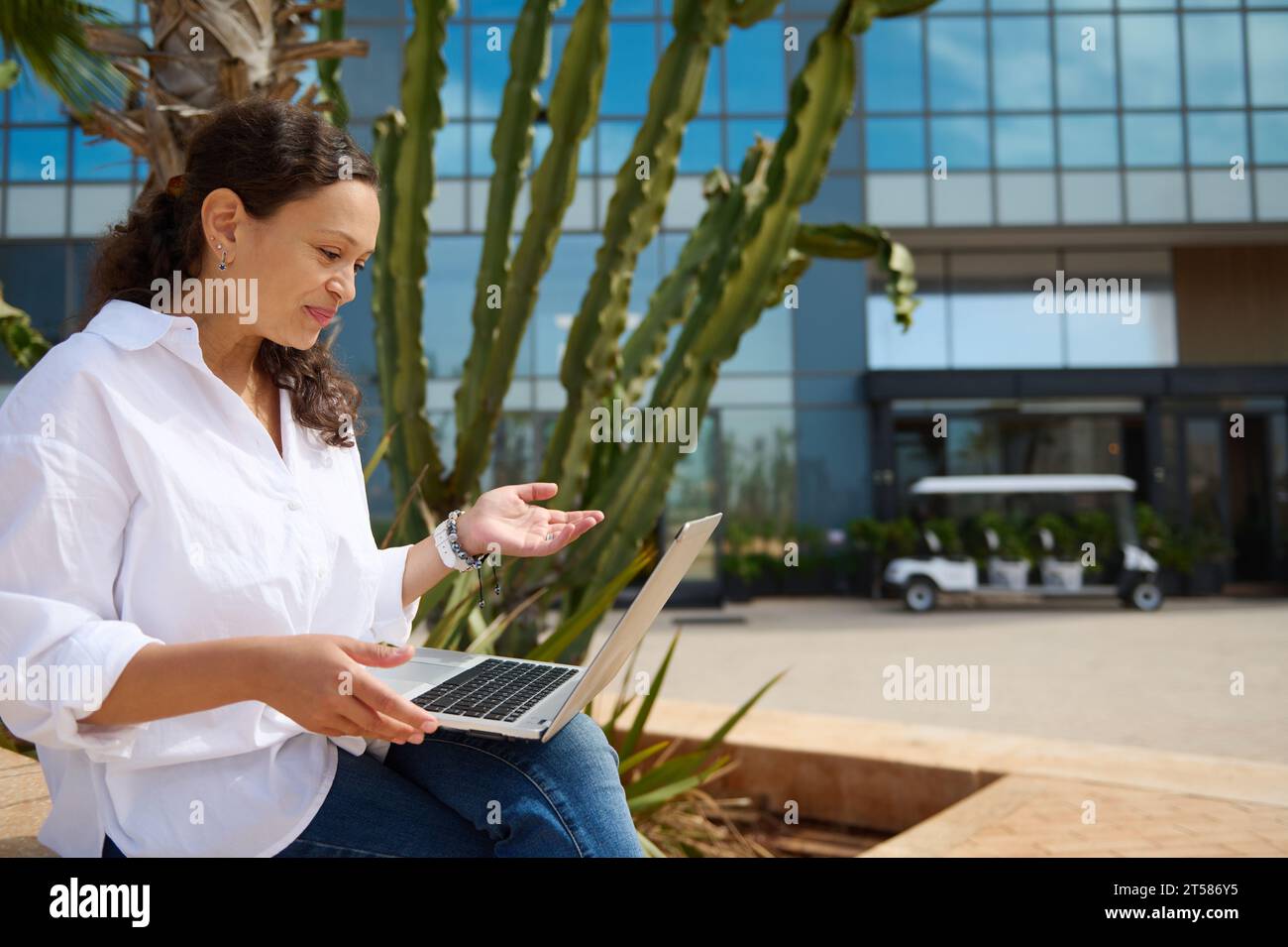Side portrait of a female freelance entrepreneur using laptop ...