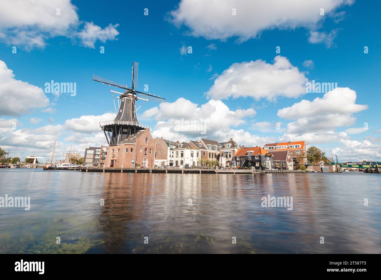 View of Haarlem city centre with the illuminated historic mill and ...