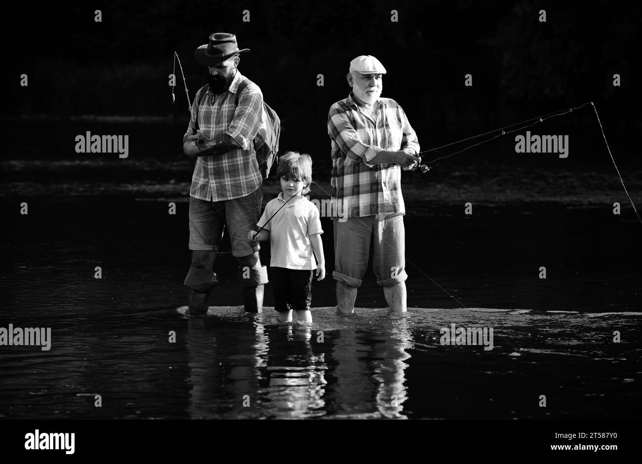 Fly fishing for trout. Senior man fishing with son and grandson ...