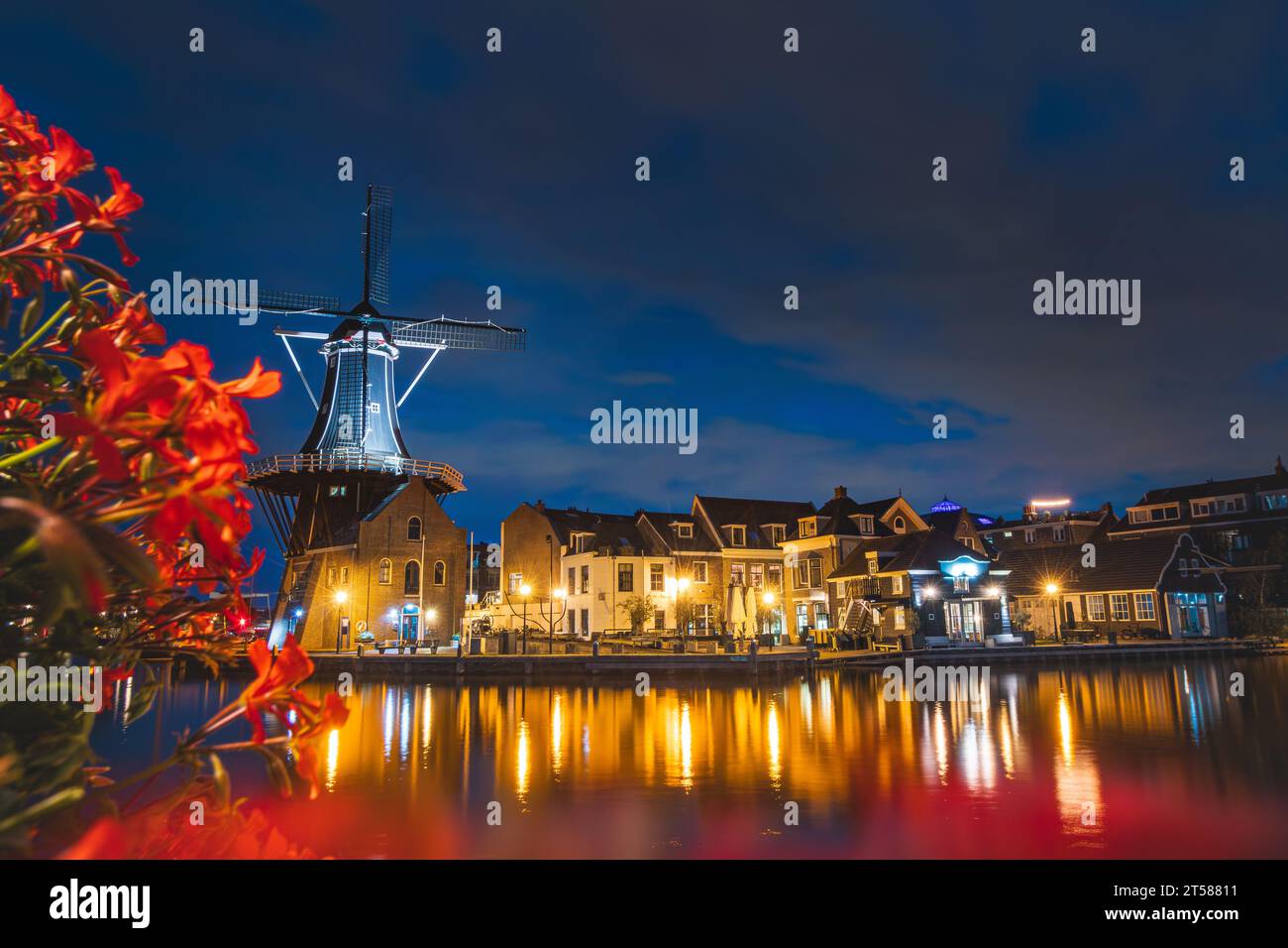 Night view of Haarlem city centre with the illuminated historic mill ...