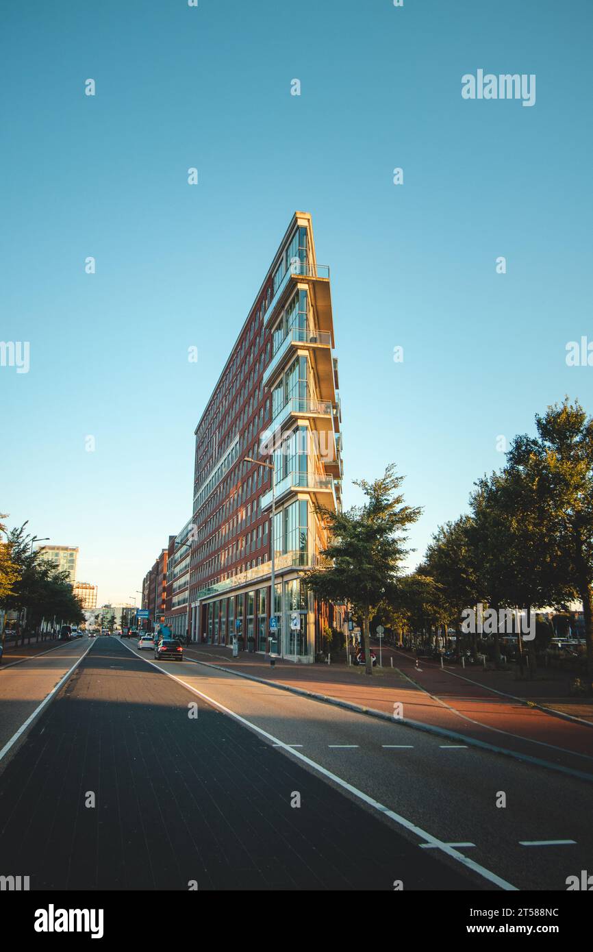 Triangular modern skyscraper on the waterfront in Amsterdam, Holland ...