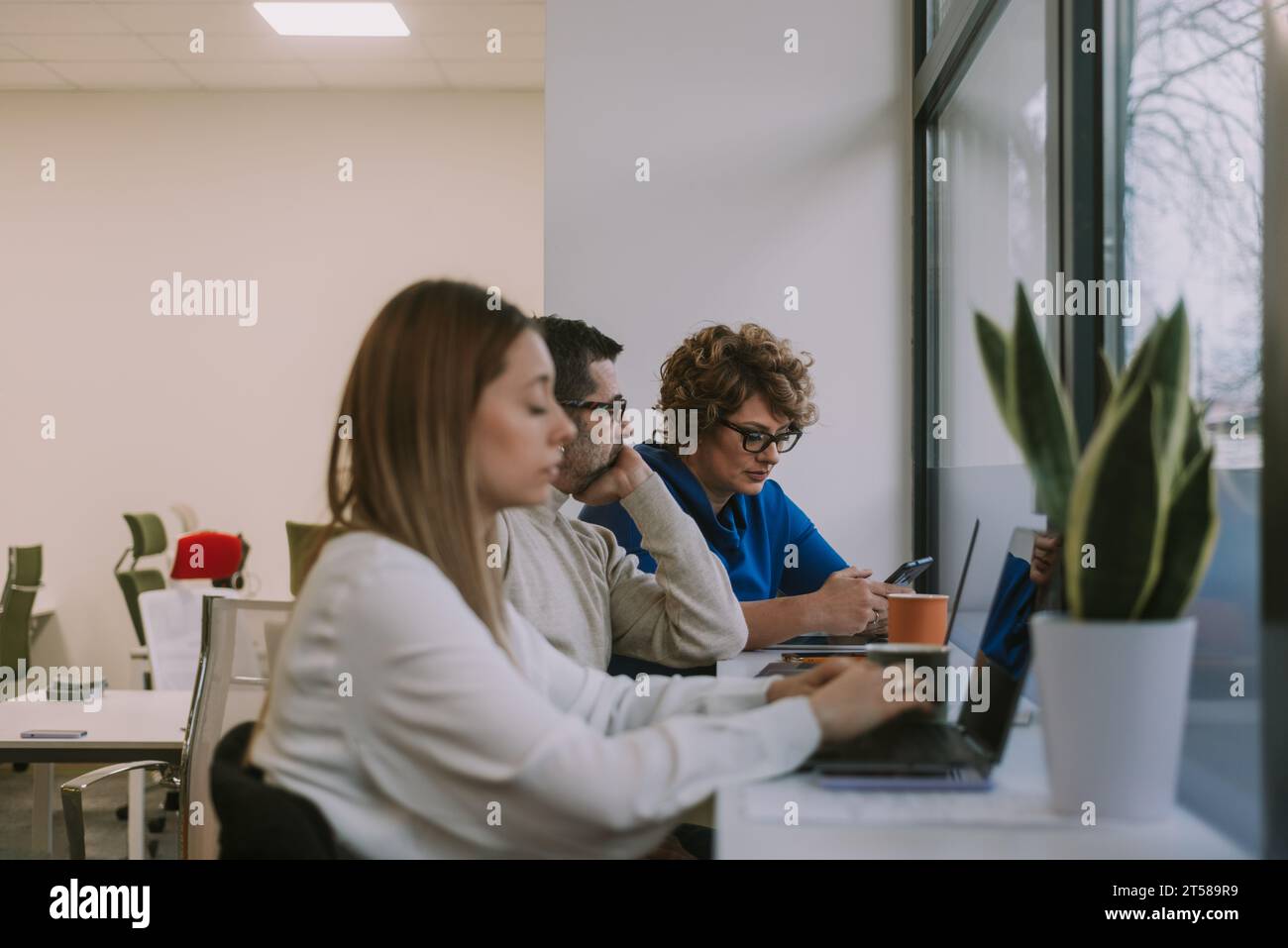 Side view shot of tired inter-generational group of workers loosing ...