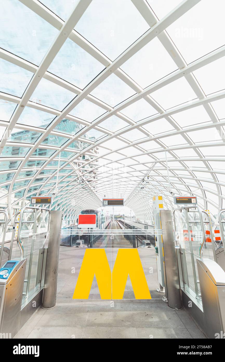 Modern tram station in Den Haag. A tunnel made of white pillars that ...