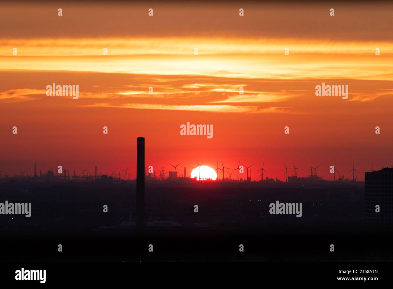 Sun setting over the horizon in Rotterdam. Red light irradiation of the ...