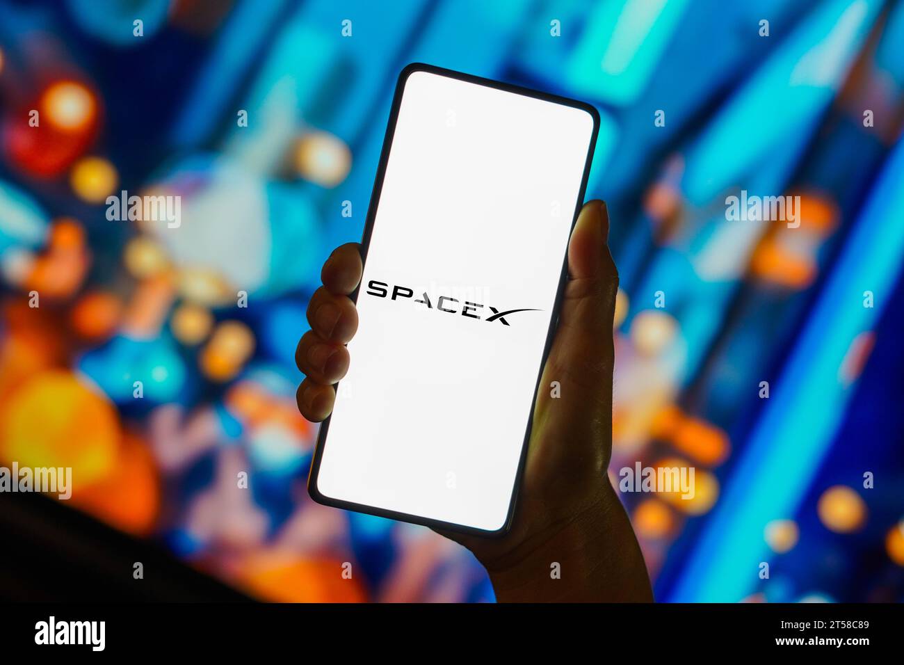 In this photo illustration, the SpaceX logo is displayed on a ...