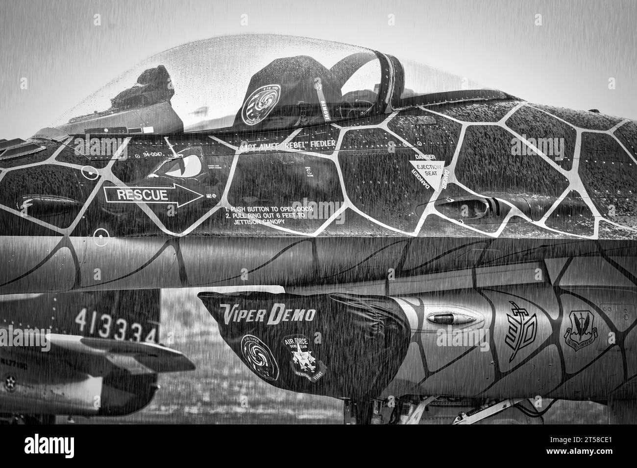 An F-16, of the US Air Force Viper Demo Team, gets rained on while ...