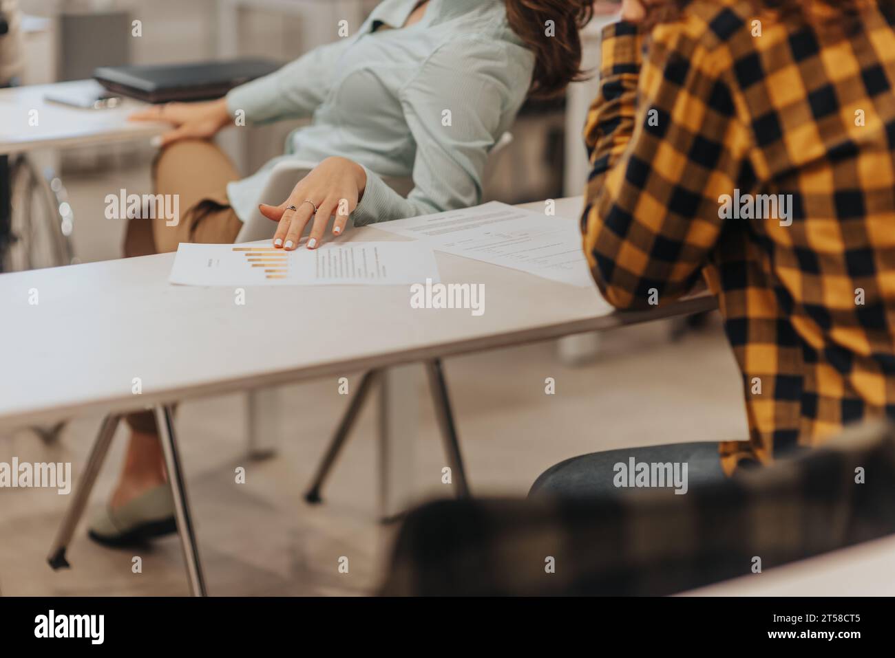 Female student cheating during exam, she is sneaking a look at her ...