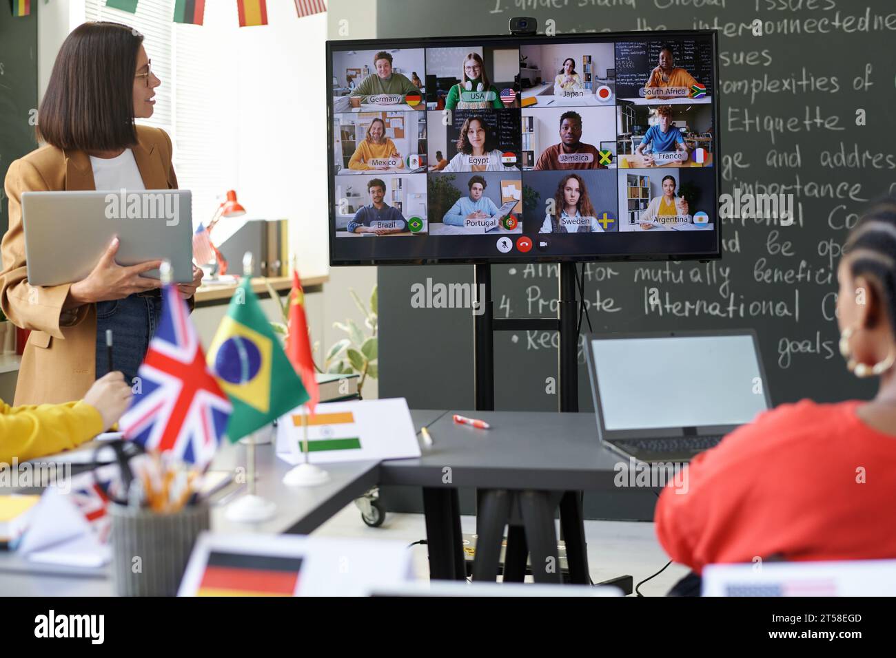 Teacher having online conference with international students in the ...