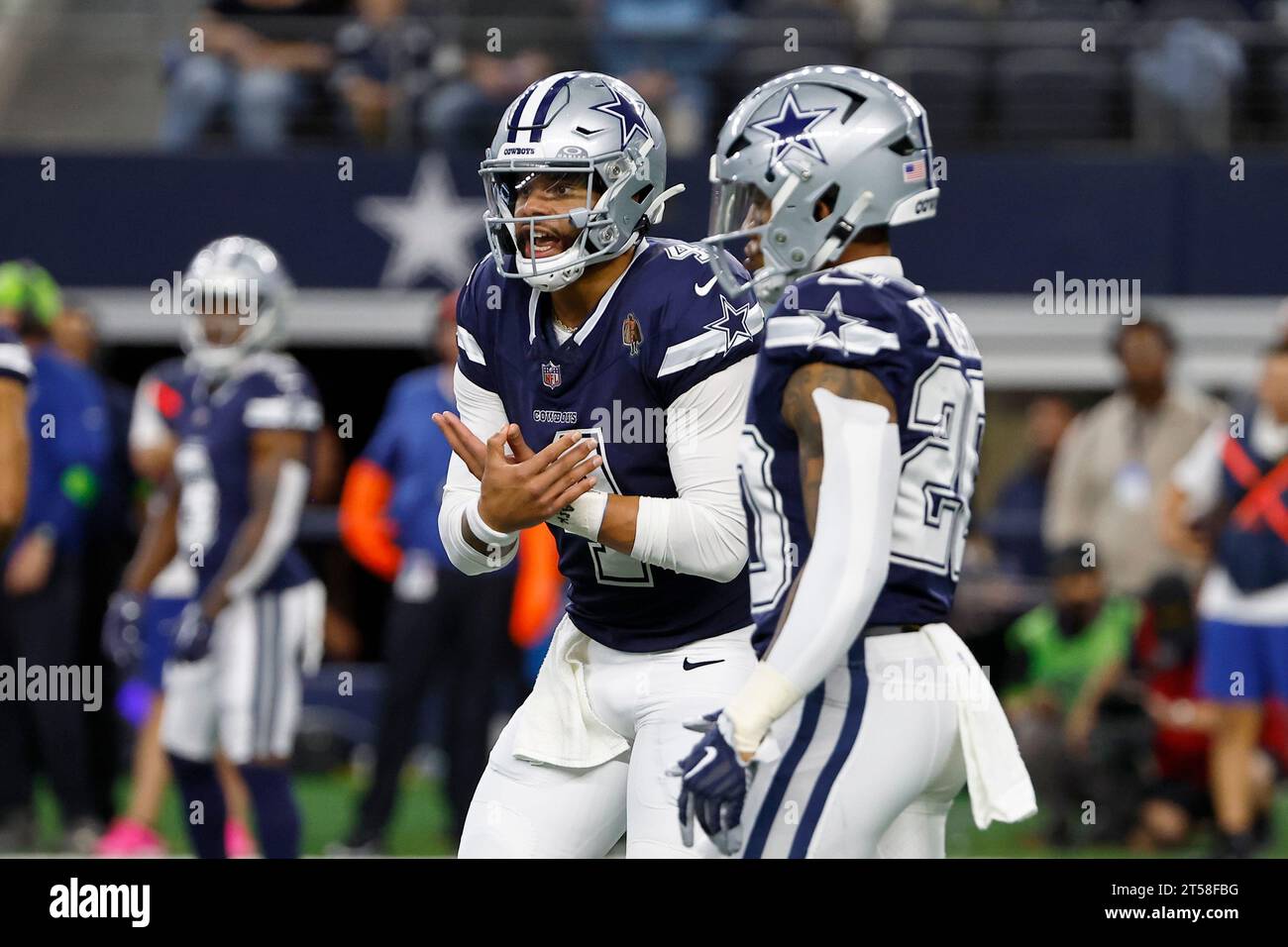 Dallas Cowboys quarterback Dak Prescott, left, signals before a play in ...
