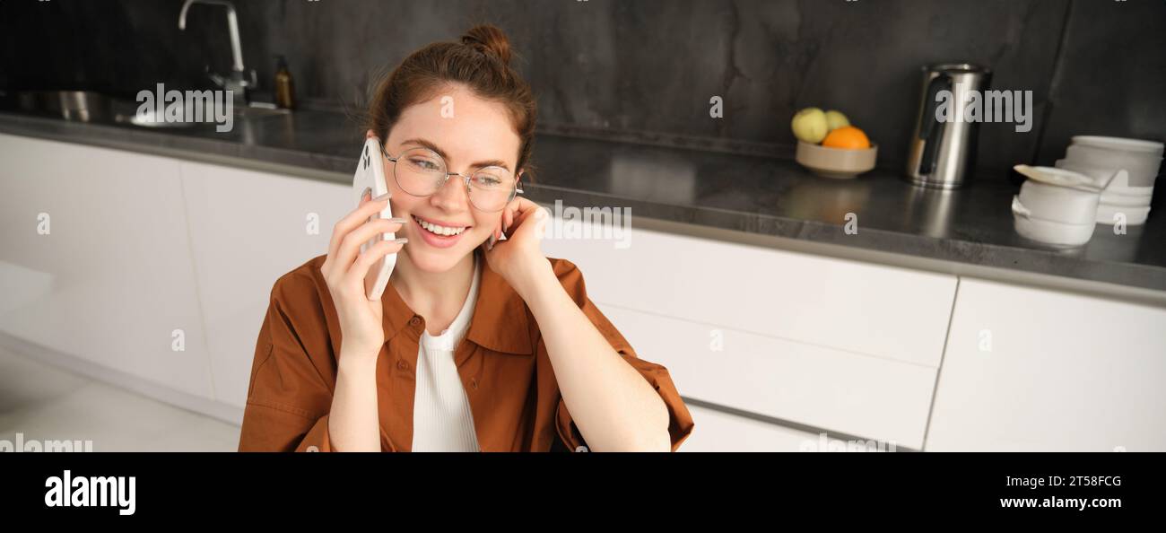 Portrait of young professional, business owner at home, talking on ...