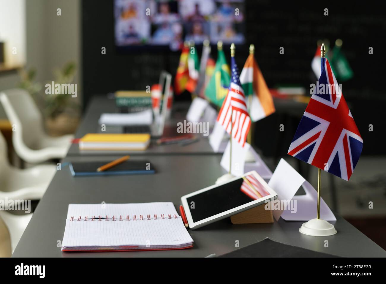 Close-up of table with flags of different countries on it in the ...