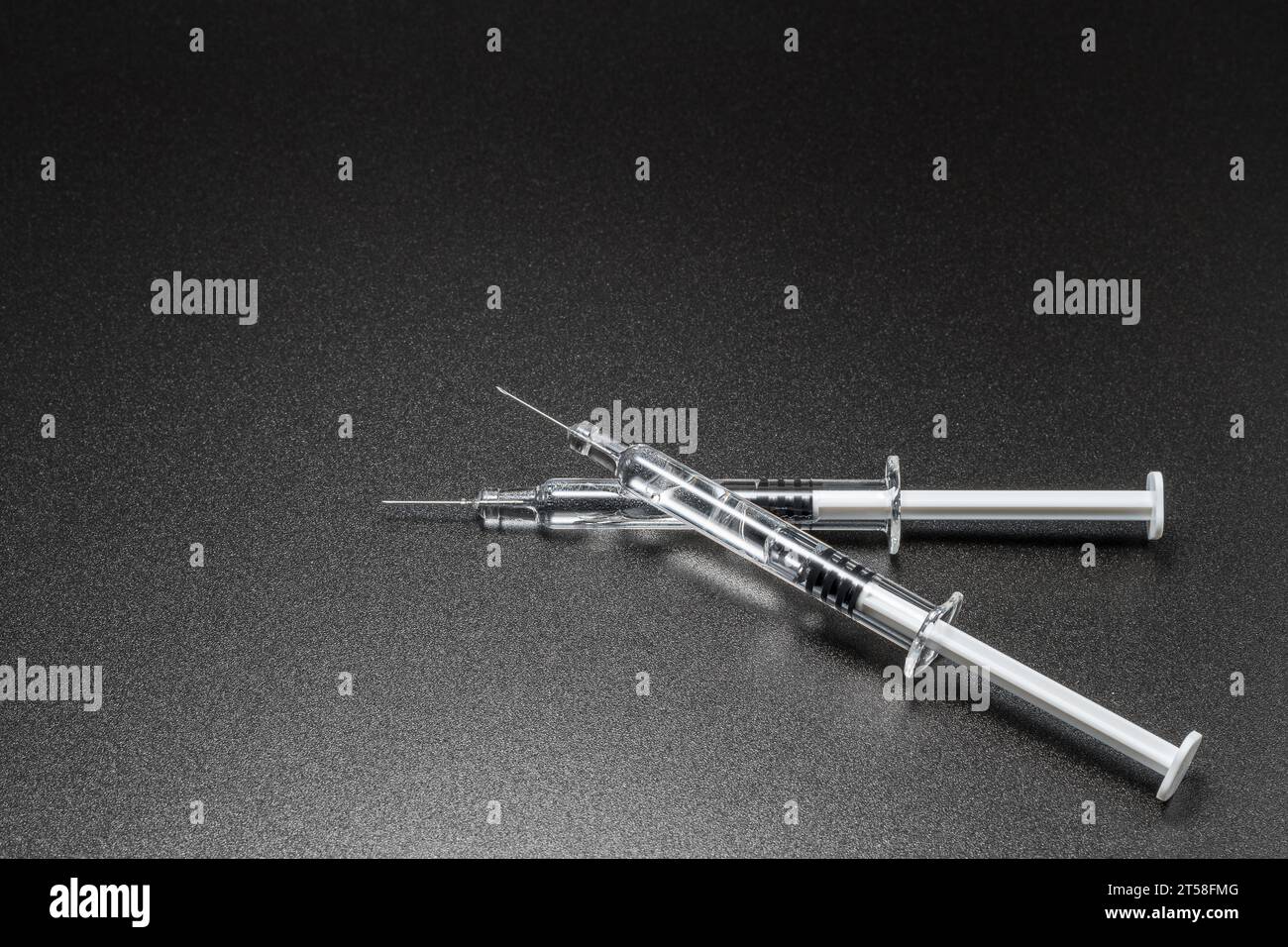 Medical syringes and needles on black background. Medical concept ...