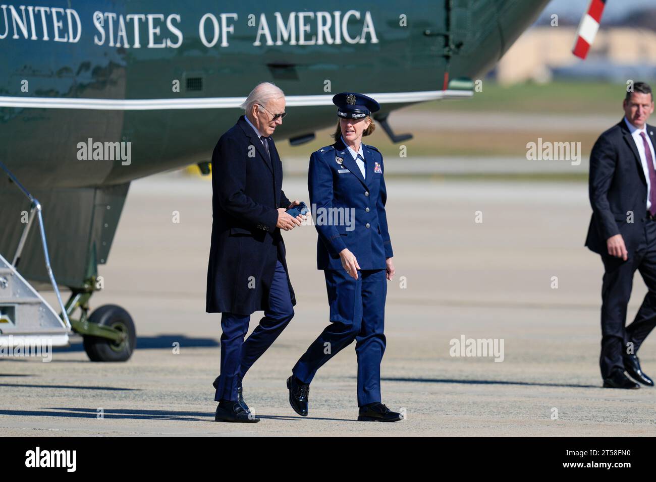 President Joe Biden walks with Col. Angela Ochoa, commander of the 89th ...