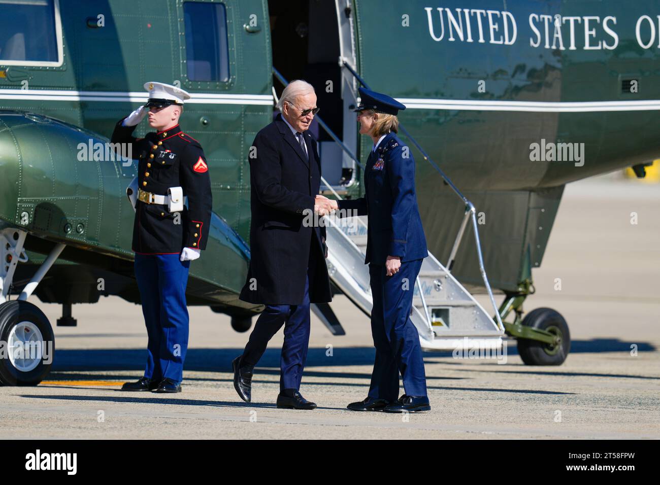 President Joe Biden shakes hands with Col. Angela Ochoa, commander of ...
