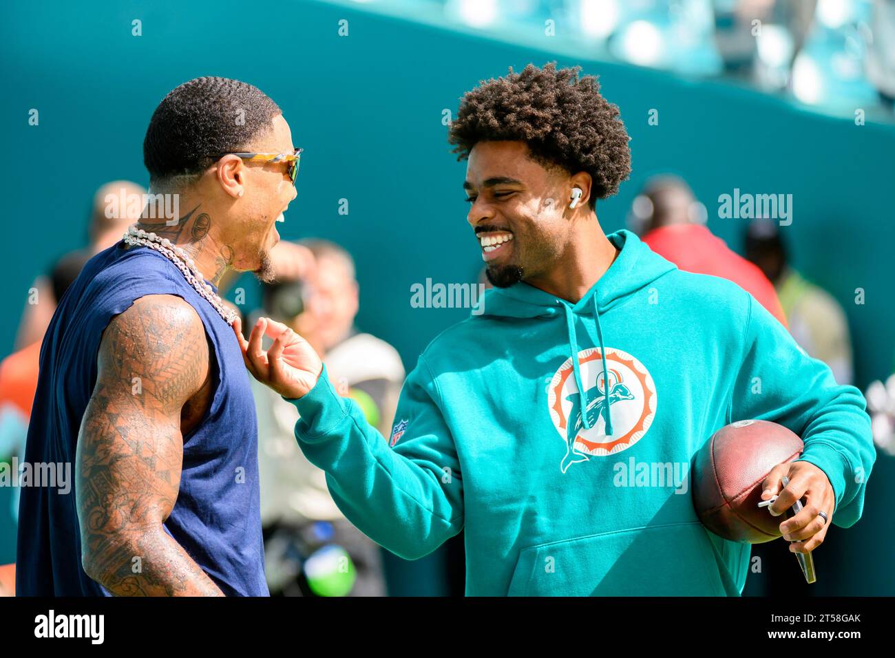New England Patriots wide receiver Kendrick Bourne (left) and Miami Dolphins running back Salvon ...