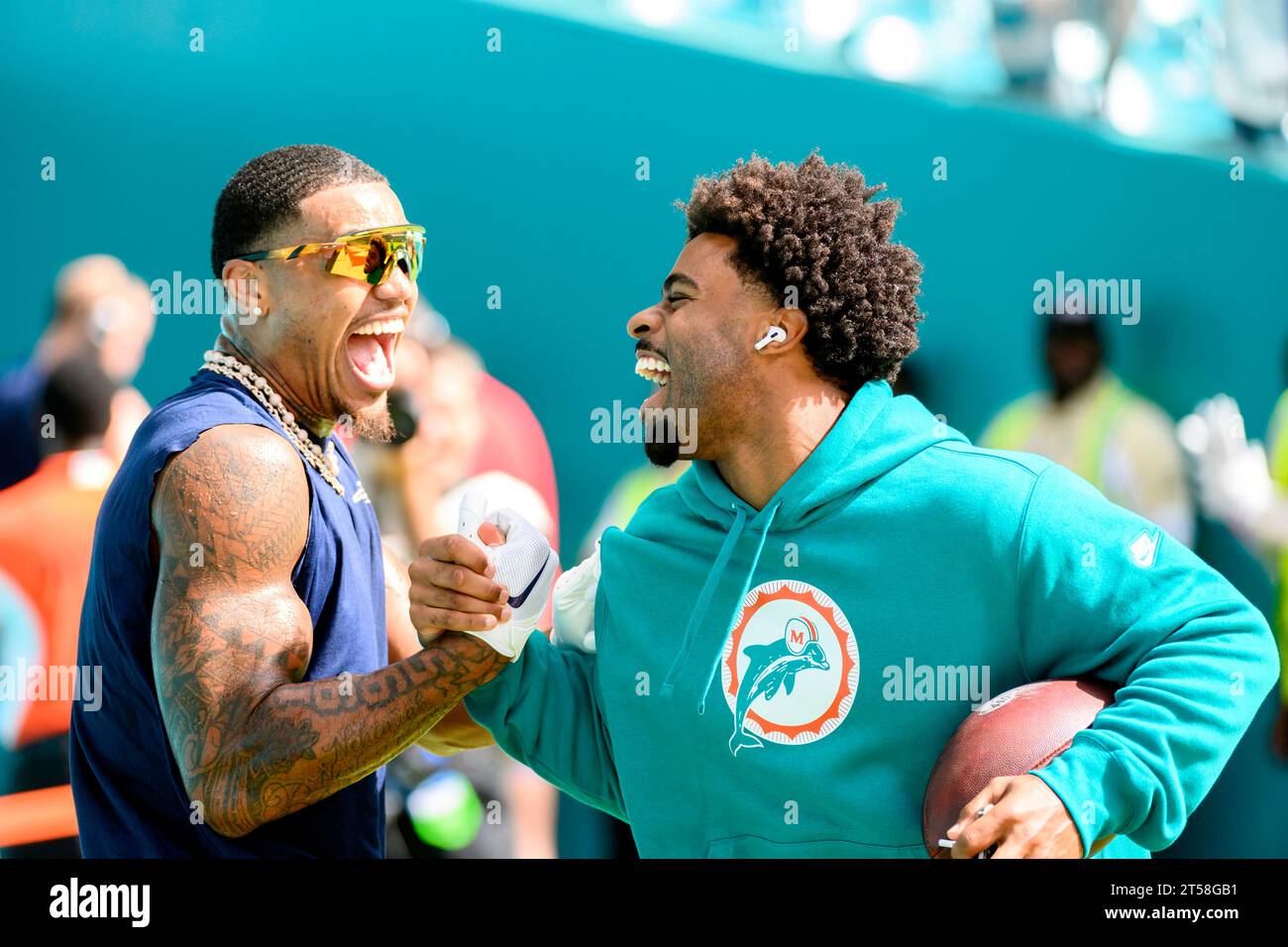 New England Patriots wide receiver Kendrick Bourne (left) and Miami Dolphins running back Salvon ...