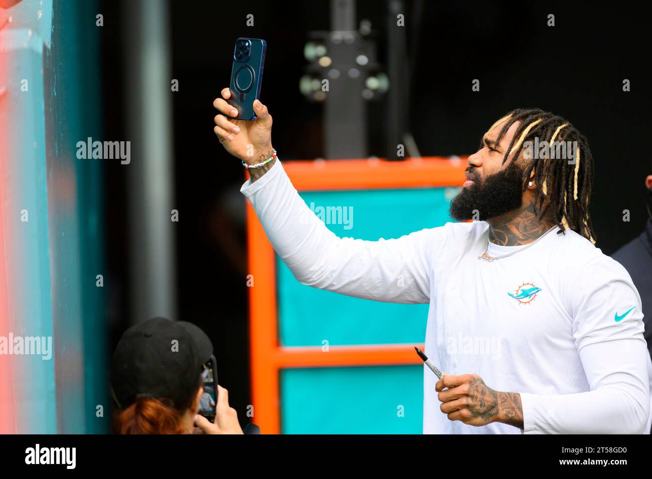 Miami Dolphins running back Raheem Mostert (31) takes a selfie with a ...