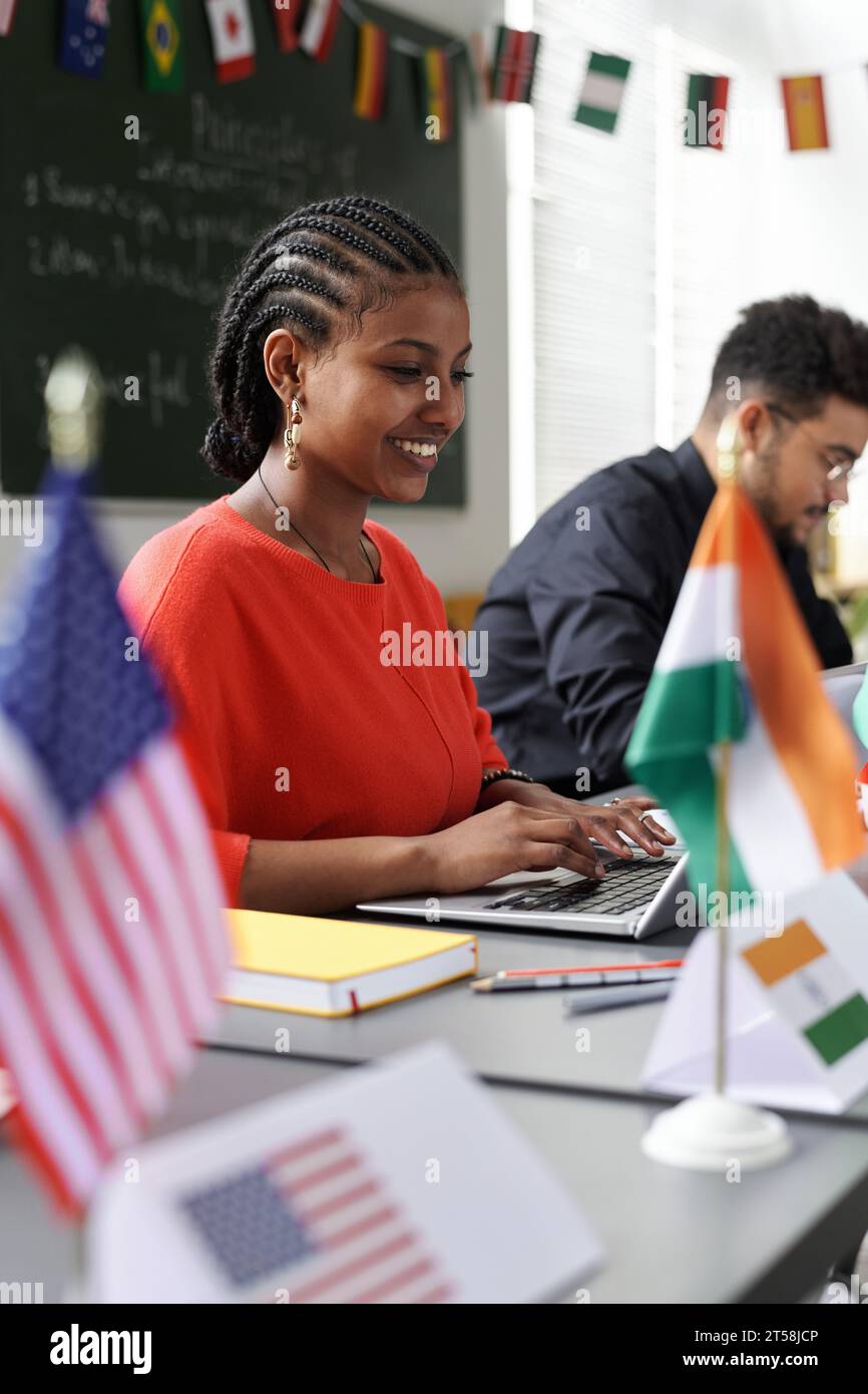 Vertical image of students using computers during lesson in the ...