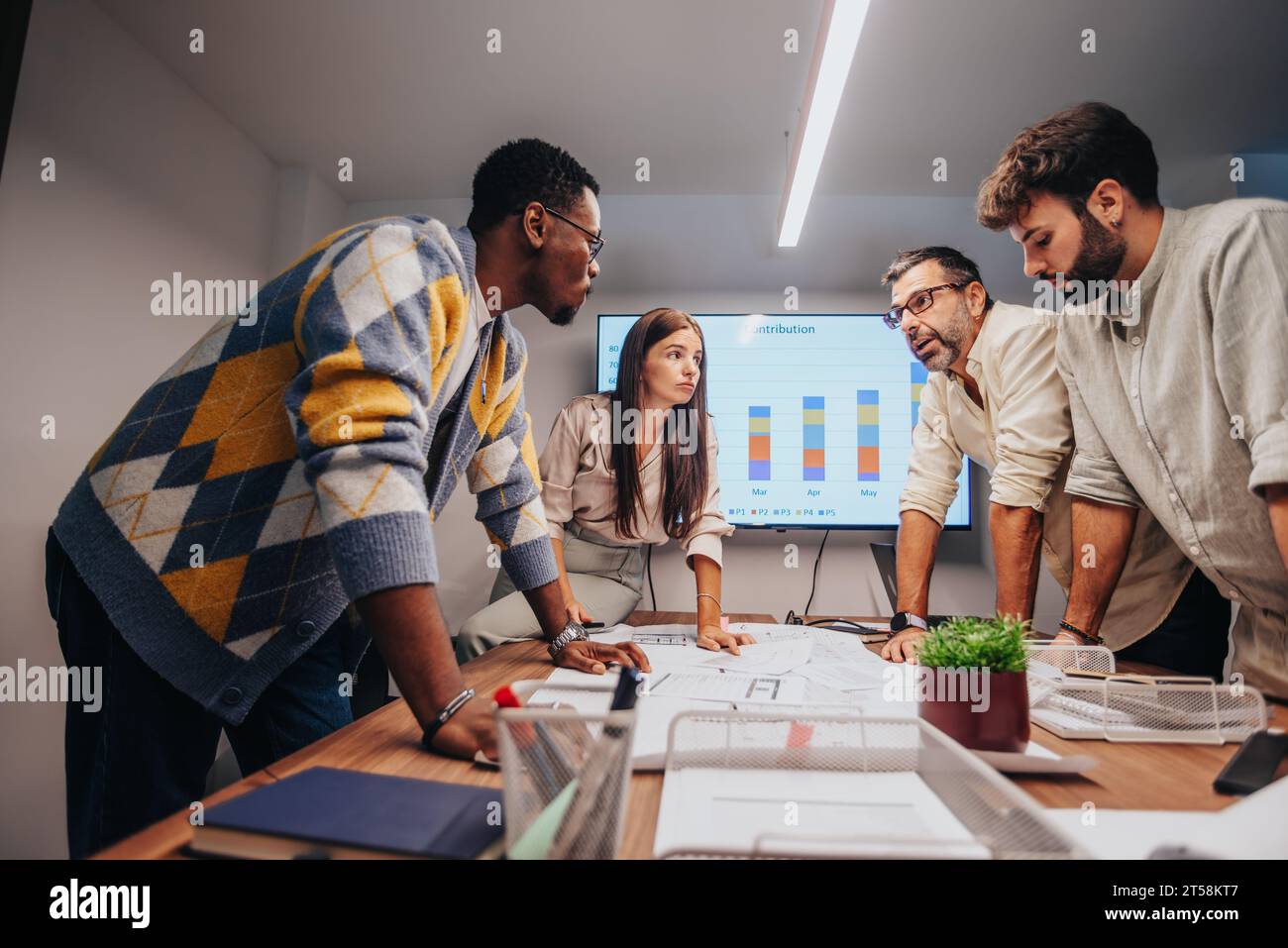 Multiracial architects and engineers collaborate in a corporate ...