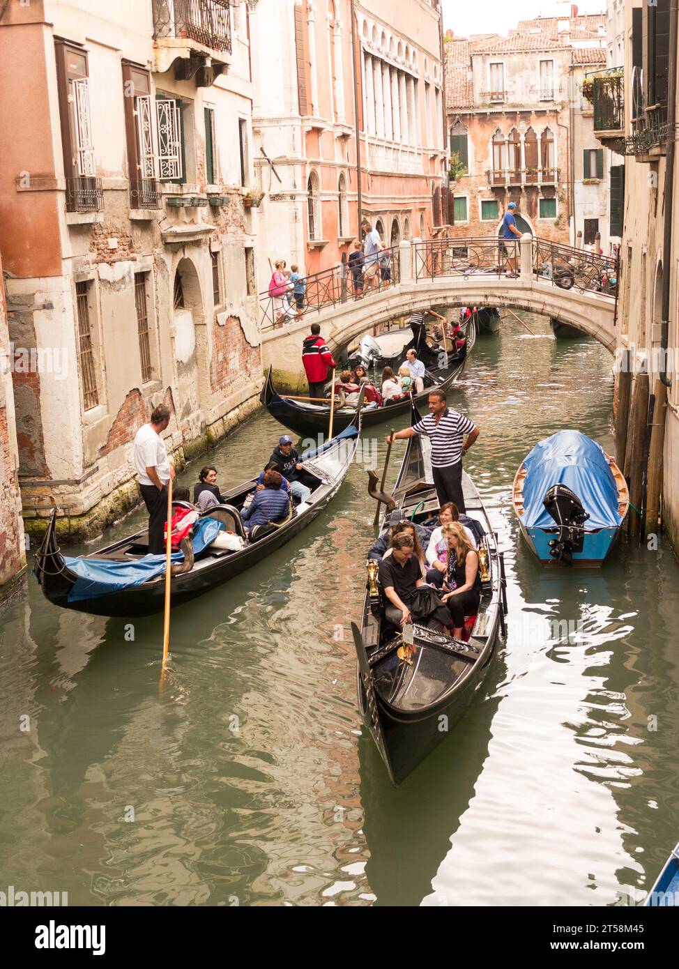 Venice canal crowded with gondolas carrying tourists Stock Photo - Alamy