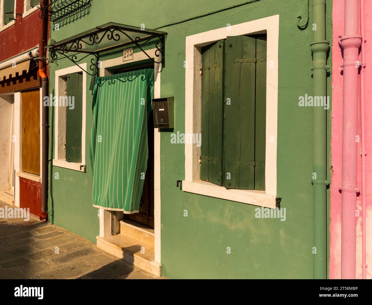A green house in Burano. Everything is green: the shutters, the door ...