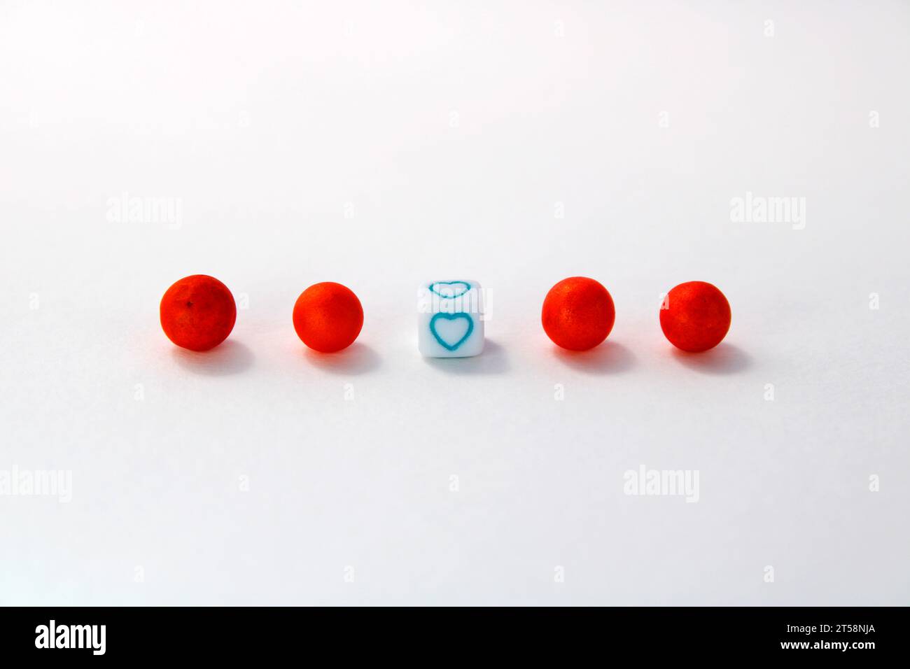 Row of red spheres and a cube in the center with a heart figure that ...