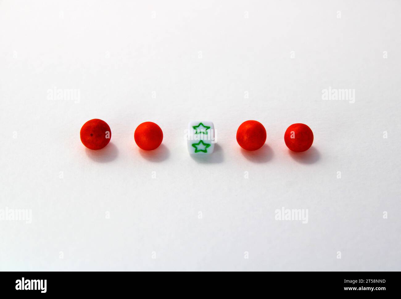 Row of red spheres and a cube in the center with a star figure that ...
