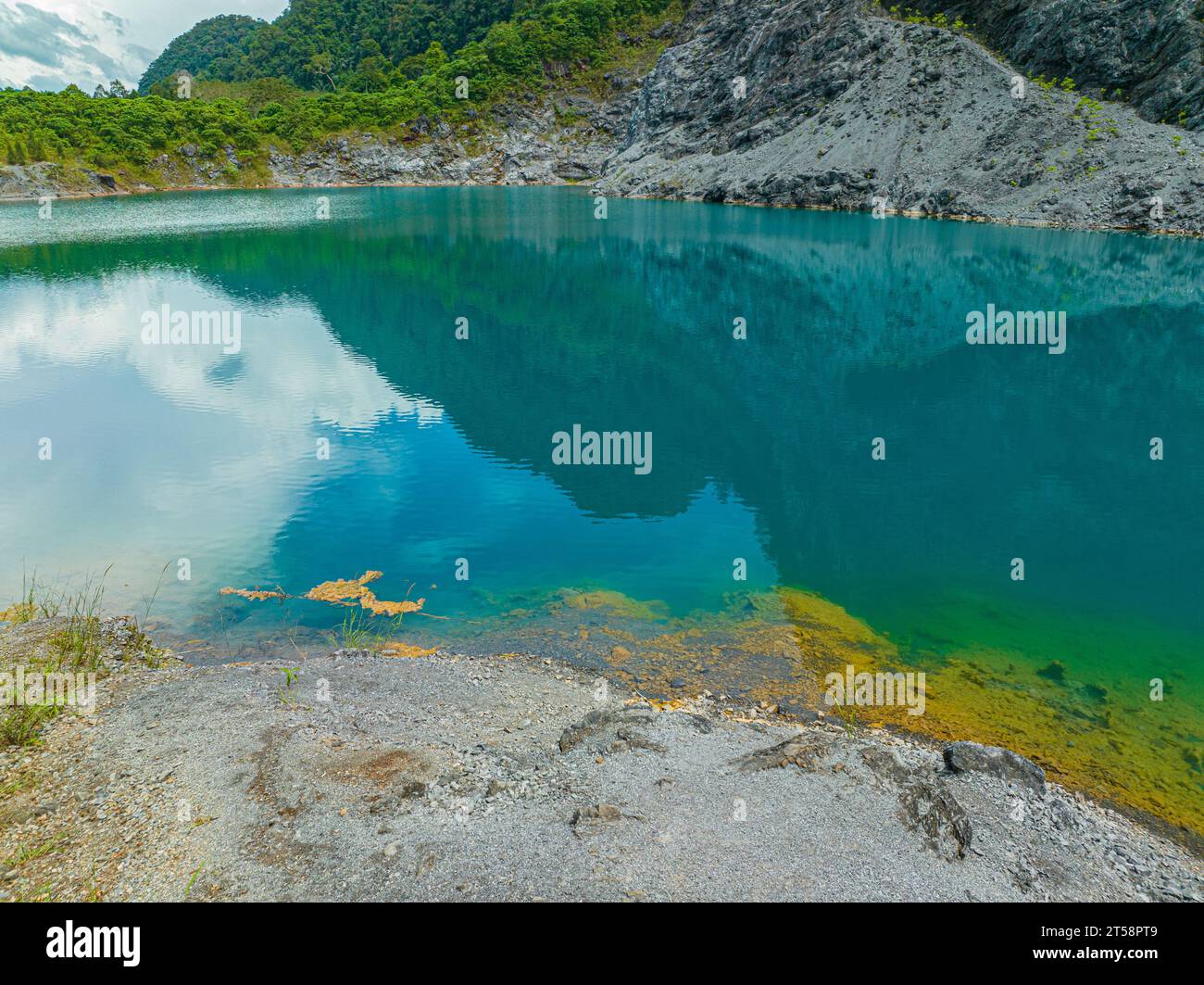 Aerial view beautiful The reflection of the blue sky in the emerald green pond. Emerald green ...