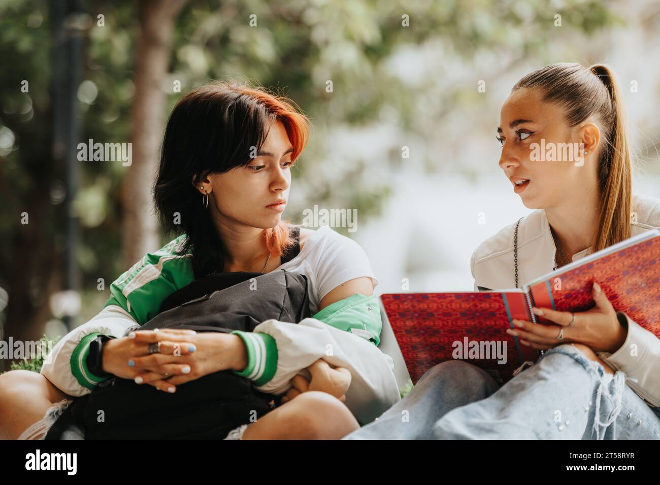 Two Girls Studying Together Outdoors, Sharing Homework and Helping Each ...