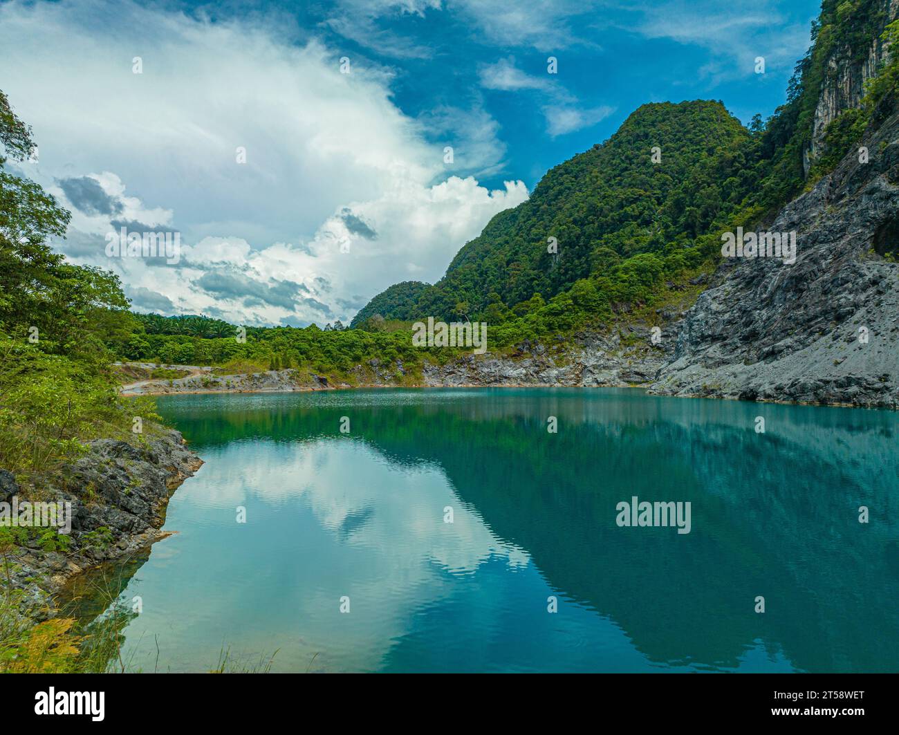 Aerial view beautiful The reflection of the blue sky in the emerald green pond. Emerald green ...