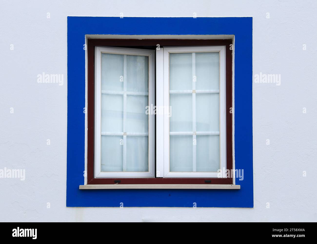 Typical Portuguese facade with White wooden window and curtain on ...