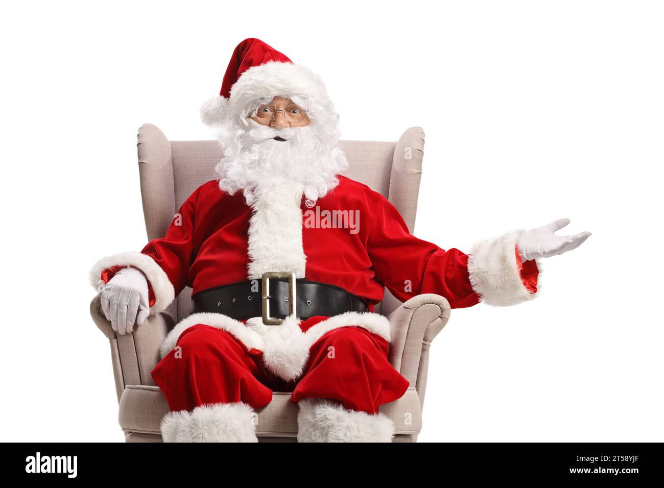 Santa claus seated in an armchair and showing something with hand ...