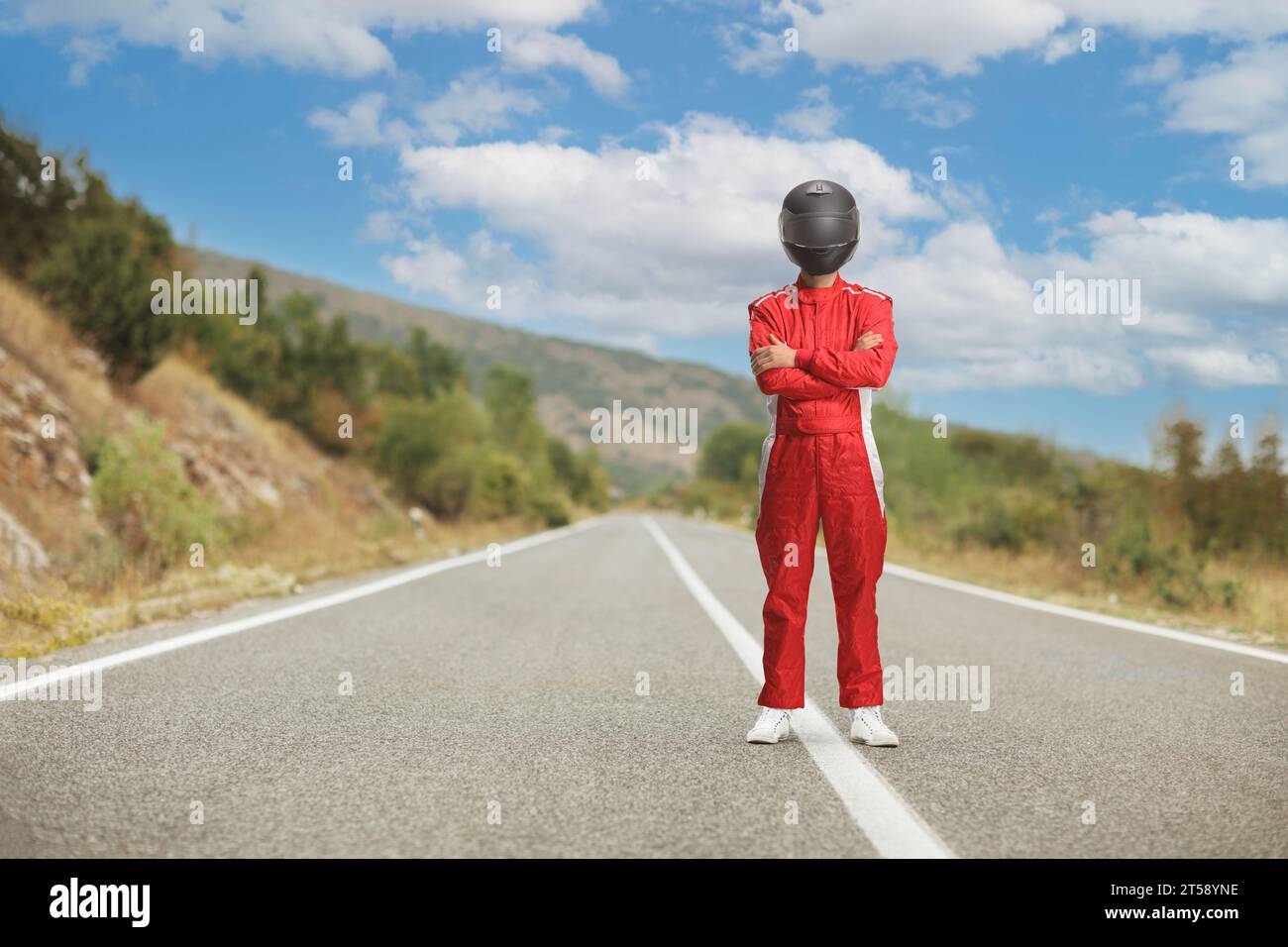 Racer in a red suit and helmet posing in the middle of an open road Stock Photo - Alamy