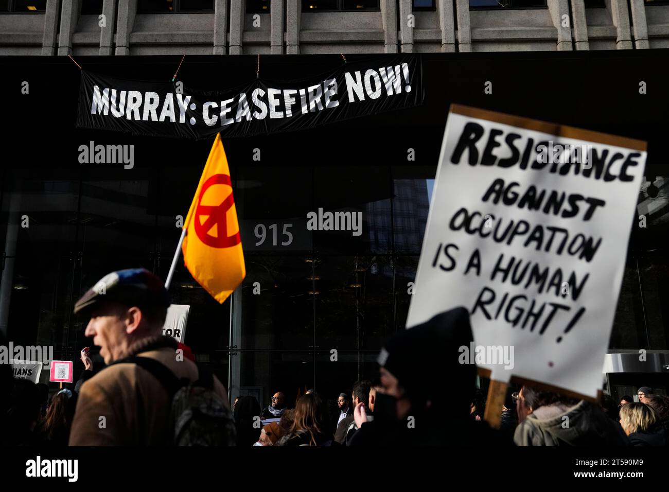 Protesters hold signs during a Jewish Voice for Peace rally that shut ...