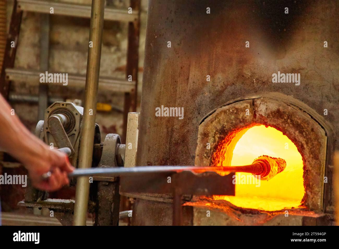 Murano glass-blowing factory. blower forming beautiful piece of glass ...