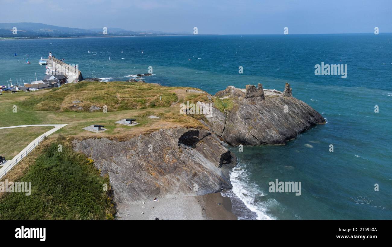 An aerial shot of a jagged rock outcrop surrounded by a vast body of ...
