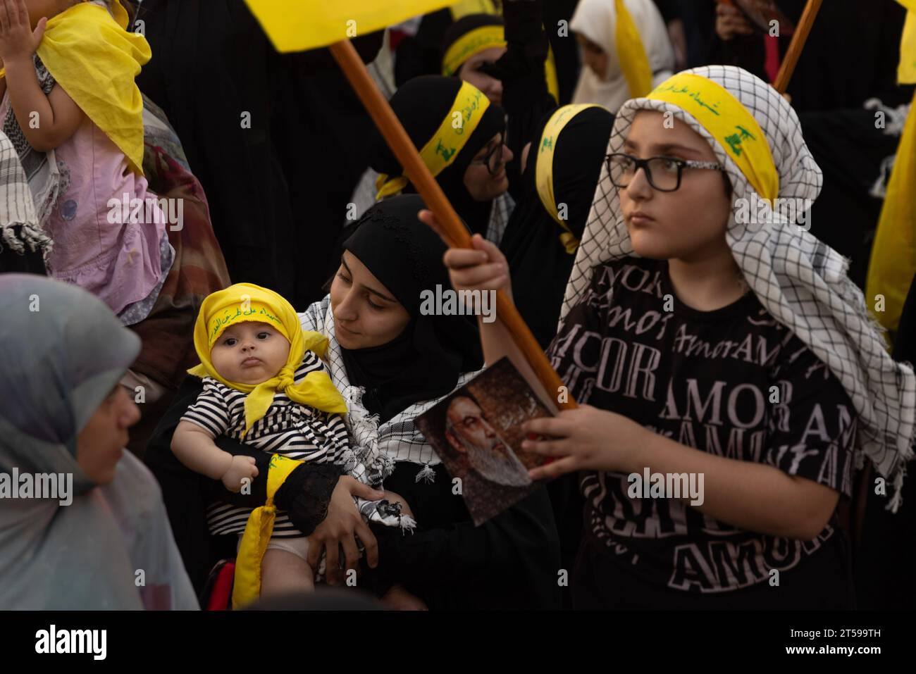 Beirut, Lebanon. 3rd Nov, 2023. A woman holds a baby wearing a ...