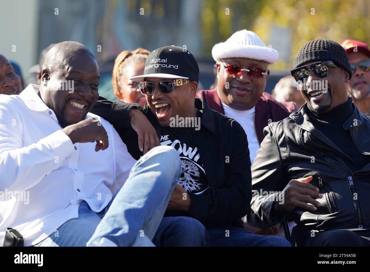 From left, Ray Luv, Money-B, E-40 and MC Hammer laugh during a street ...