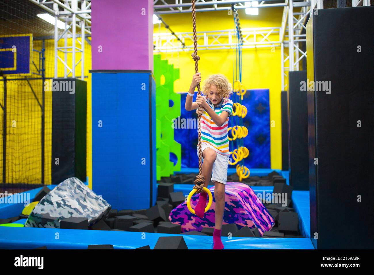 Child jumping in trampoline park. Bounce fun on kids birthday party ...
