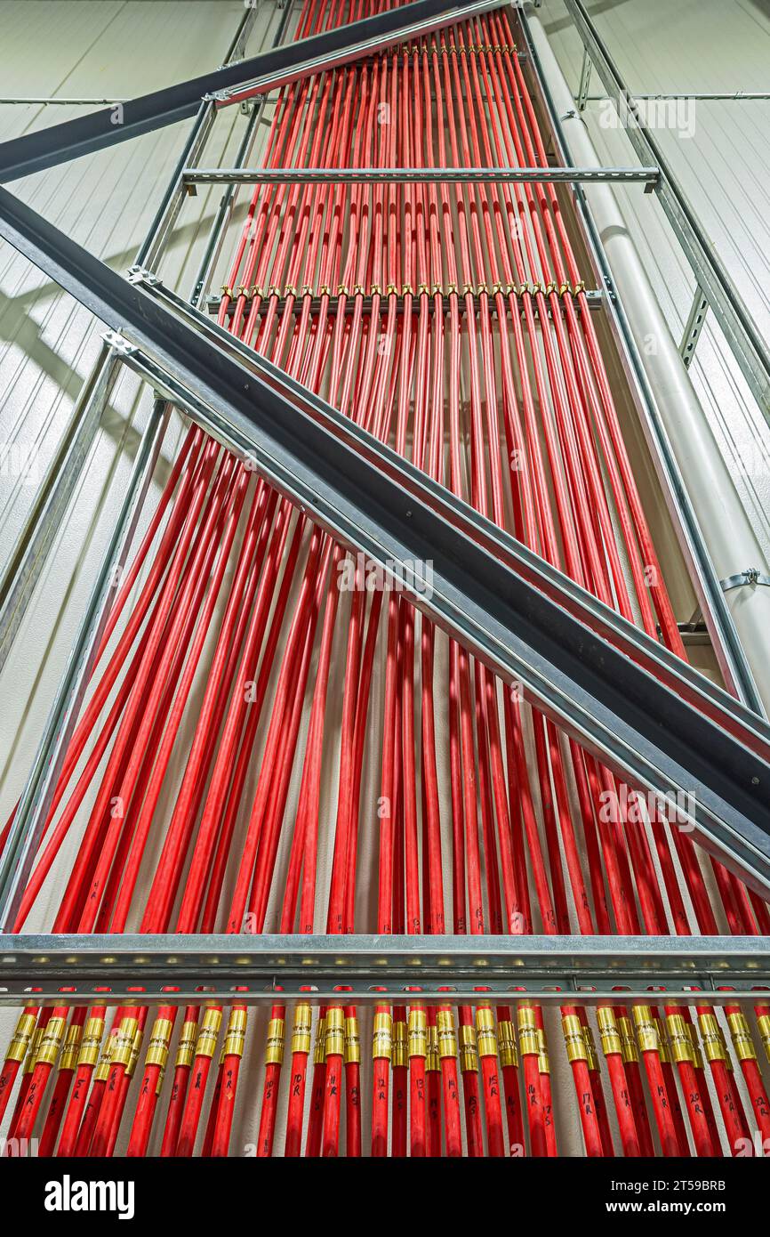 Red coolant hoses descend from the roof of a cold-storage facility to ...