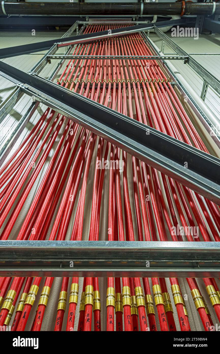 Red coolant hoses descend from the roof of a cold-storage facility to ...