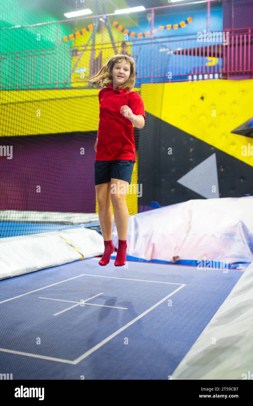 Child jumping in trampoline park. Bounce fun on kids birthday party ...