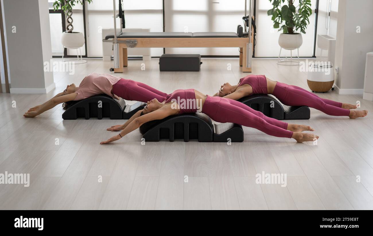 Balanced Body Pilates Arc. Three asian women exercising on pilates arc ...