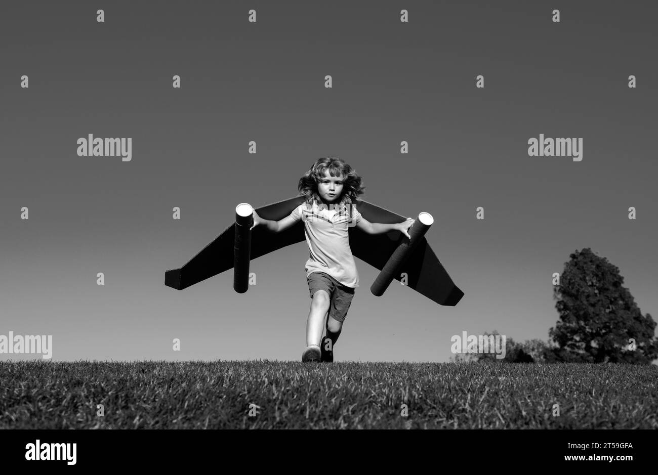 Boy child with wings at sky imagines a pilot and dreams of flying. Kids ...